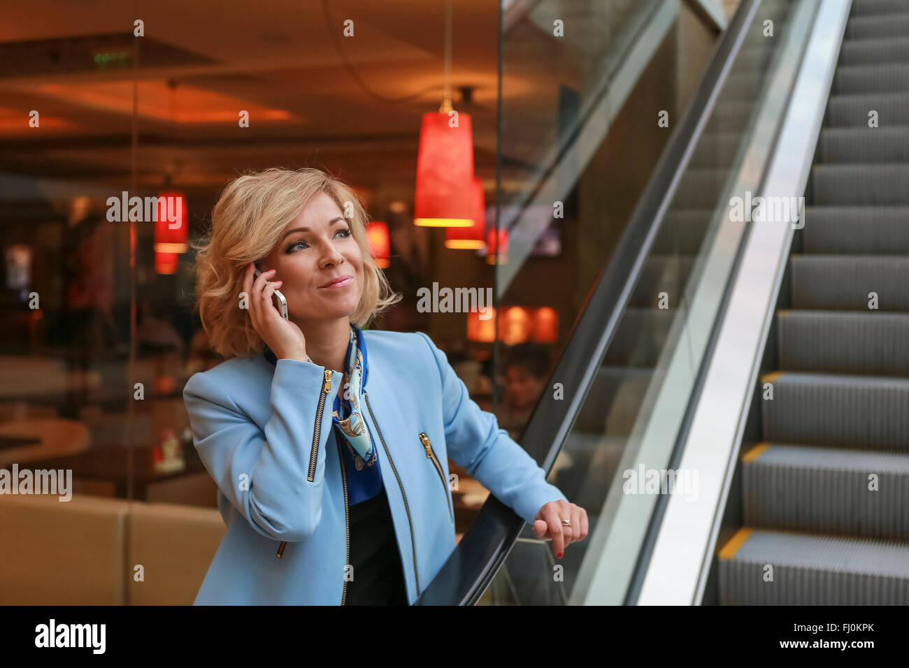 Young woman talking on cell phone chatting Stock Photo - Alamy