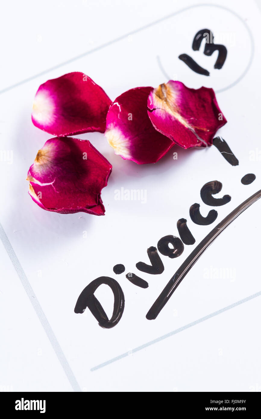 the word divorce hand written on a dry erase calendar with a dead rose ...