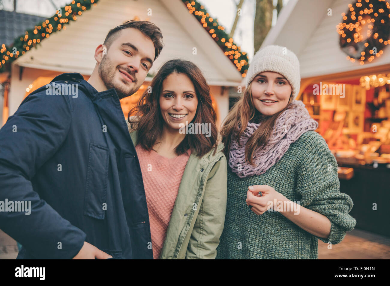 Portrait of three friends on the Christmas Market Stock Photo - Alamy
