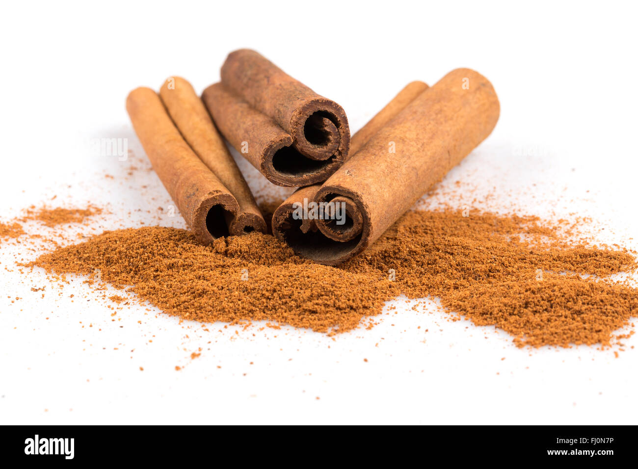 cinnamon sticks with powder isolated on white background Stock Photo ...