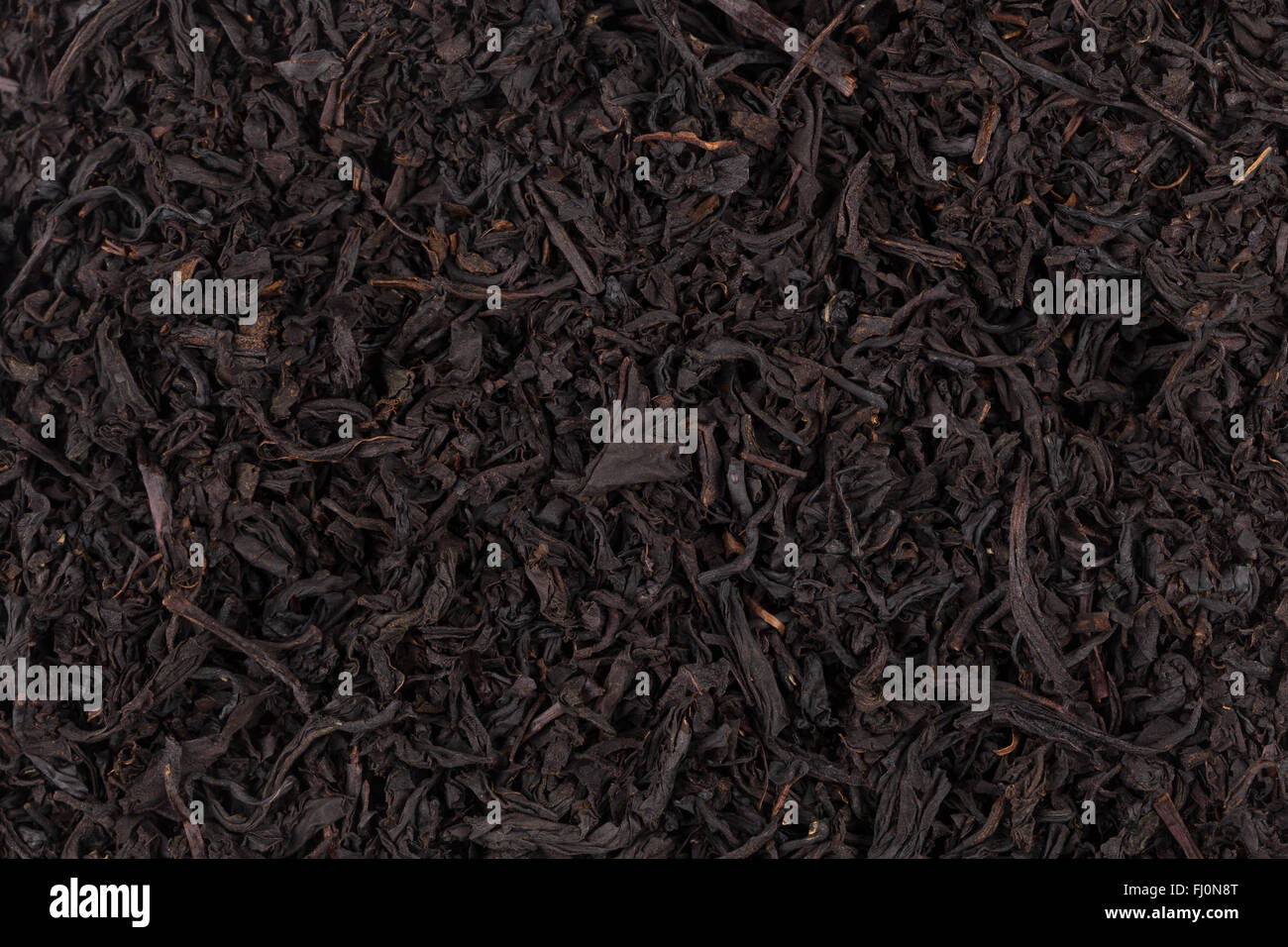 dry black tea leaves close up of texture for background Stock Photo - Alamy