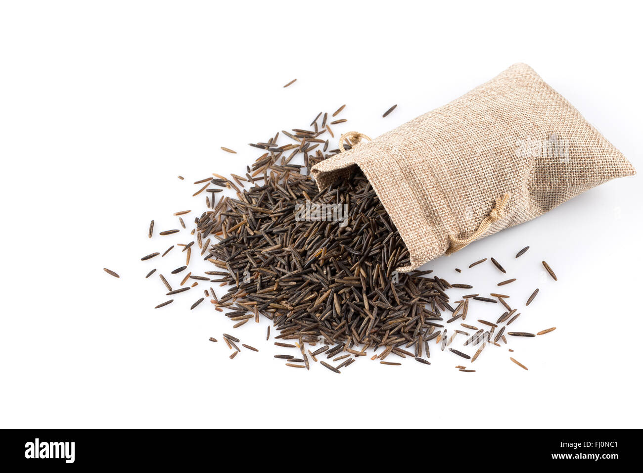 Close up image of a heap of wild rice on white background in a hessian ...