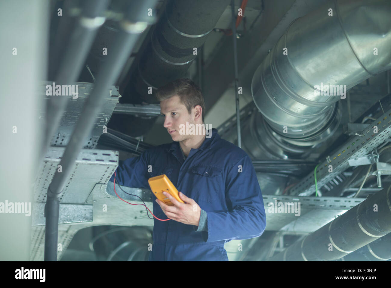 Person checking technical device hi-res stock photography and images ...