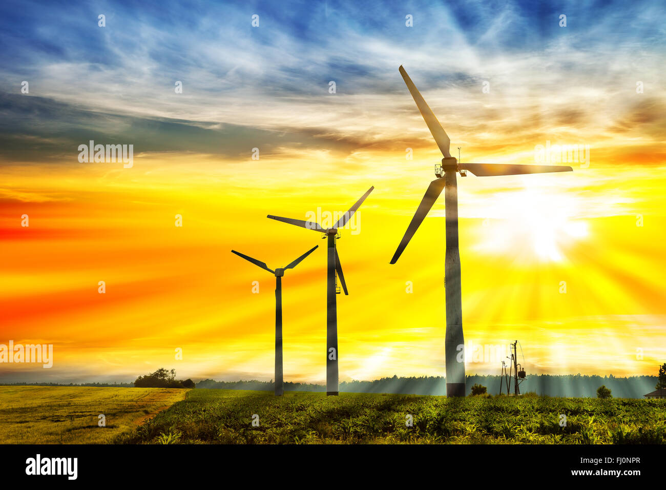 Eco power in wind turbine farm with sunset Stock Photo - Alamy