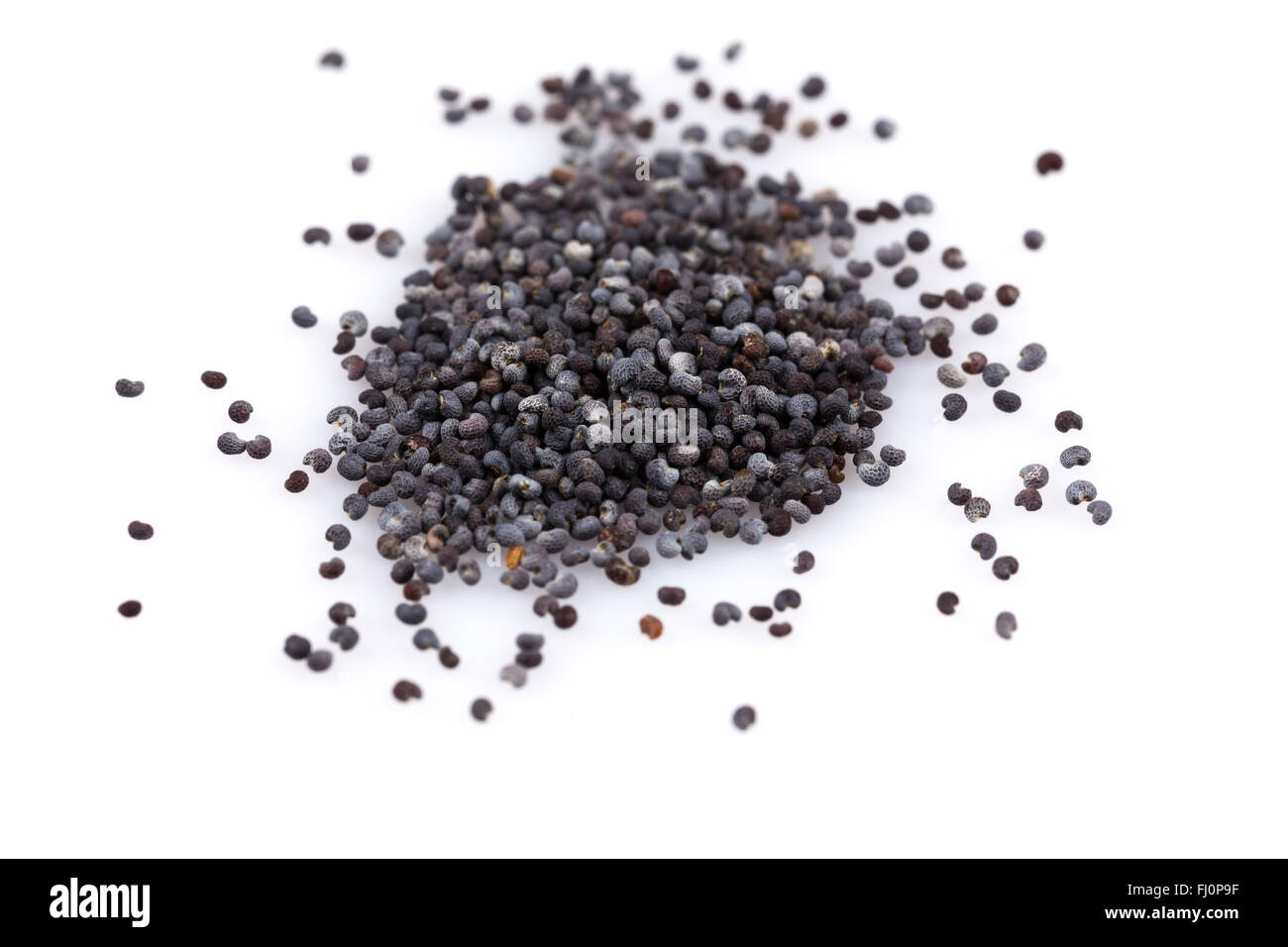 Poppy seeds heap close up isolated on white background Stock Photo - Alamy