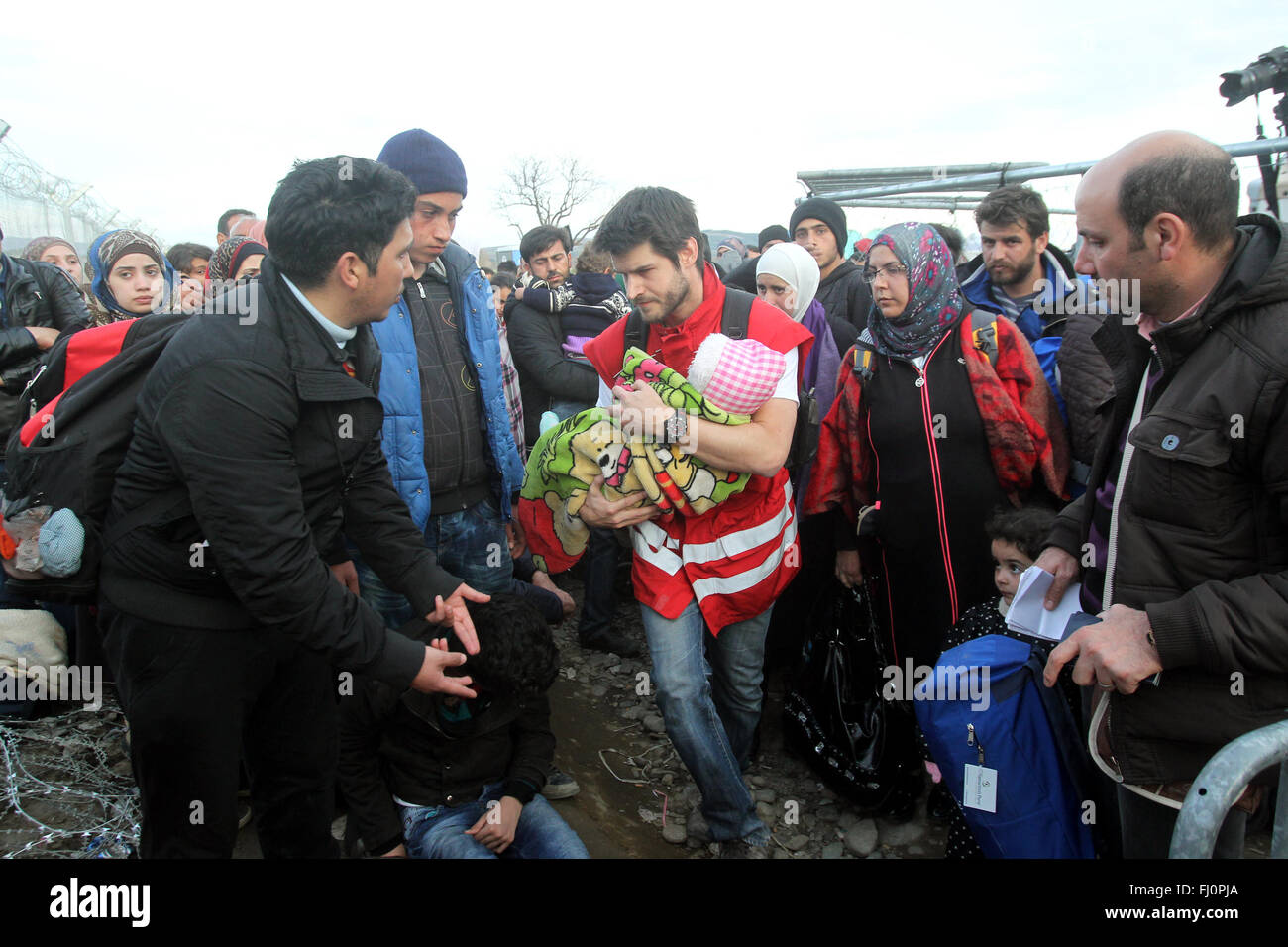 Athens, Greece. 27th Feb, 2016. Refugees cross the border between ...