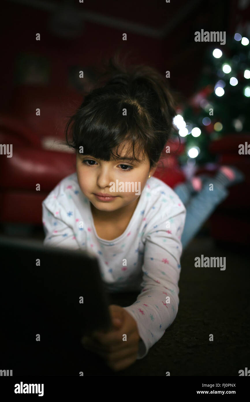 Portrait of little girl using digital tablet at home Stock Photo - Alamy