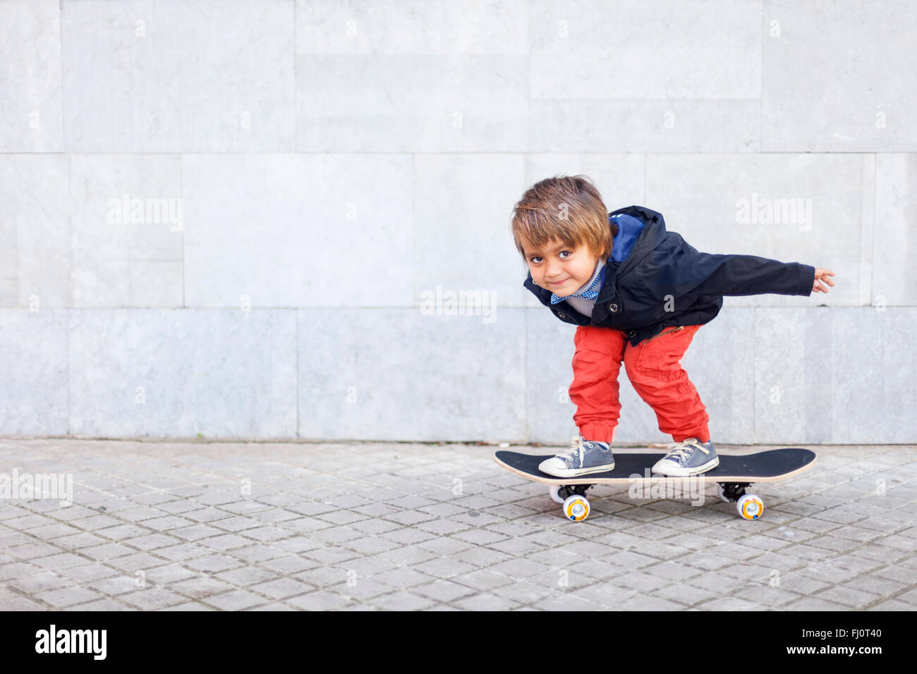 Portrait of little boy balancing on skateboard Stock Photo - Alamy