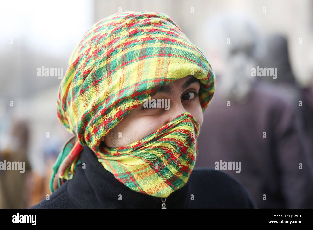 Liverpool, UK. 27th Feb, 2016. An anti fascist wearing a Kurdish head ...