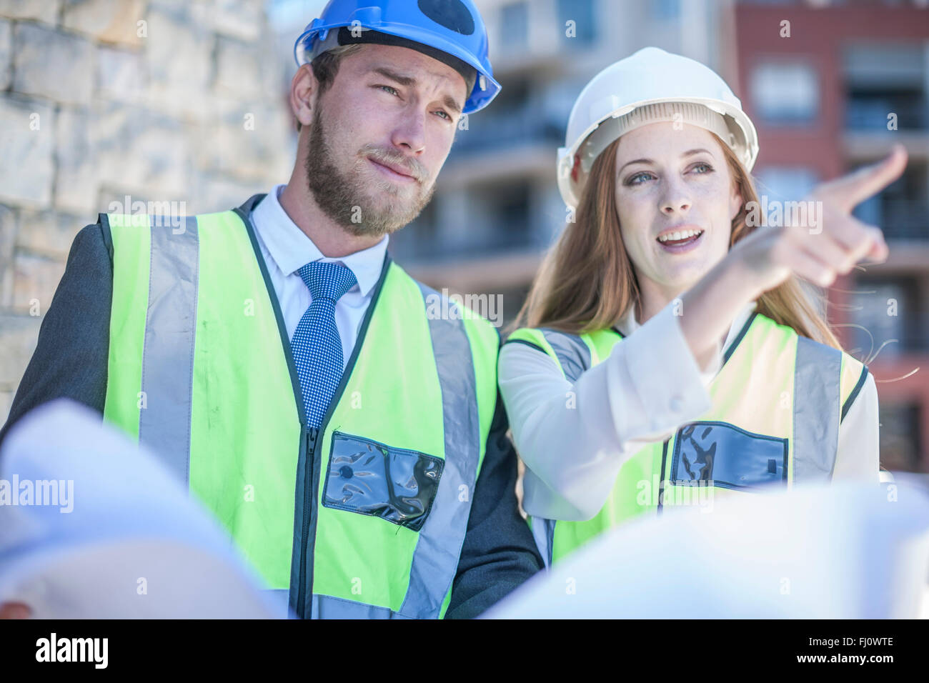 Architect and engineer at construction site, pointing Stock Photo - Alamy