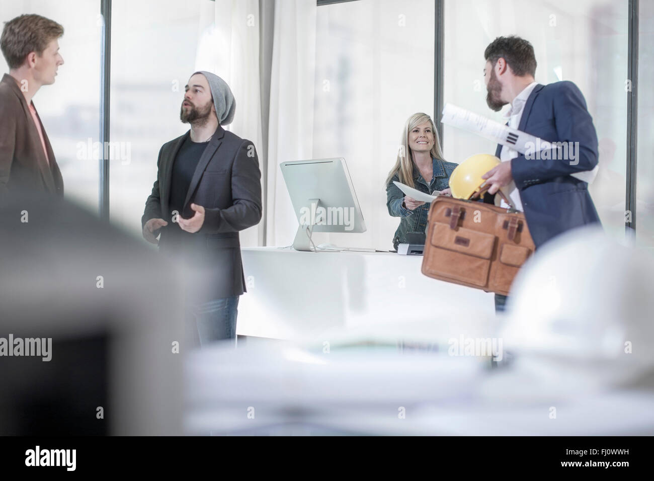 Four people talking hi-res stock photography and images - Alamy