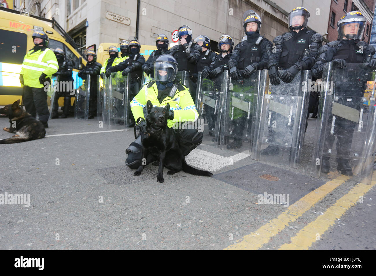 Liverpool, UK. 27th Feb, 2016. A Police Dog handler in front of a line ...