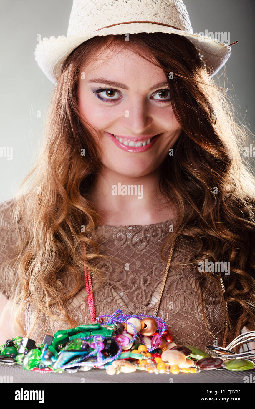 Pretty young mysterious woman in hat with many plentiful of precious ...