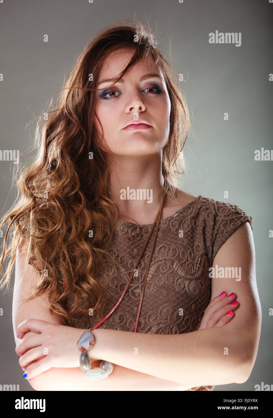 Portrait of mysterious enigmatic woman in studio on grey. Young ...