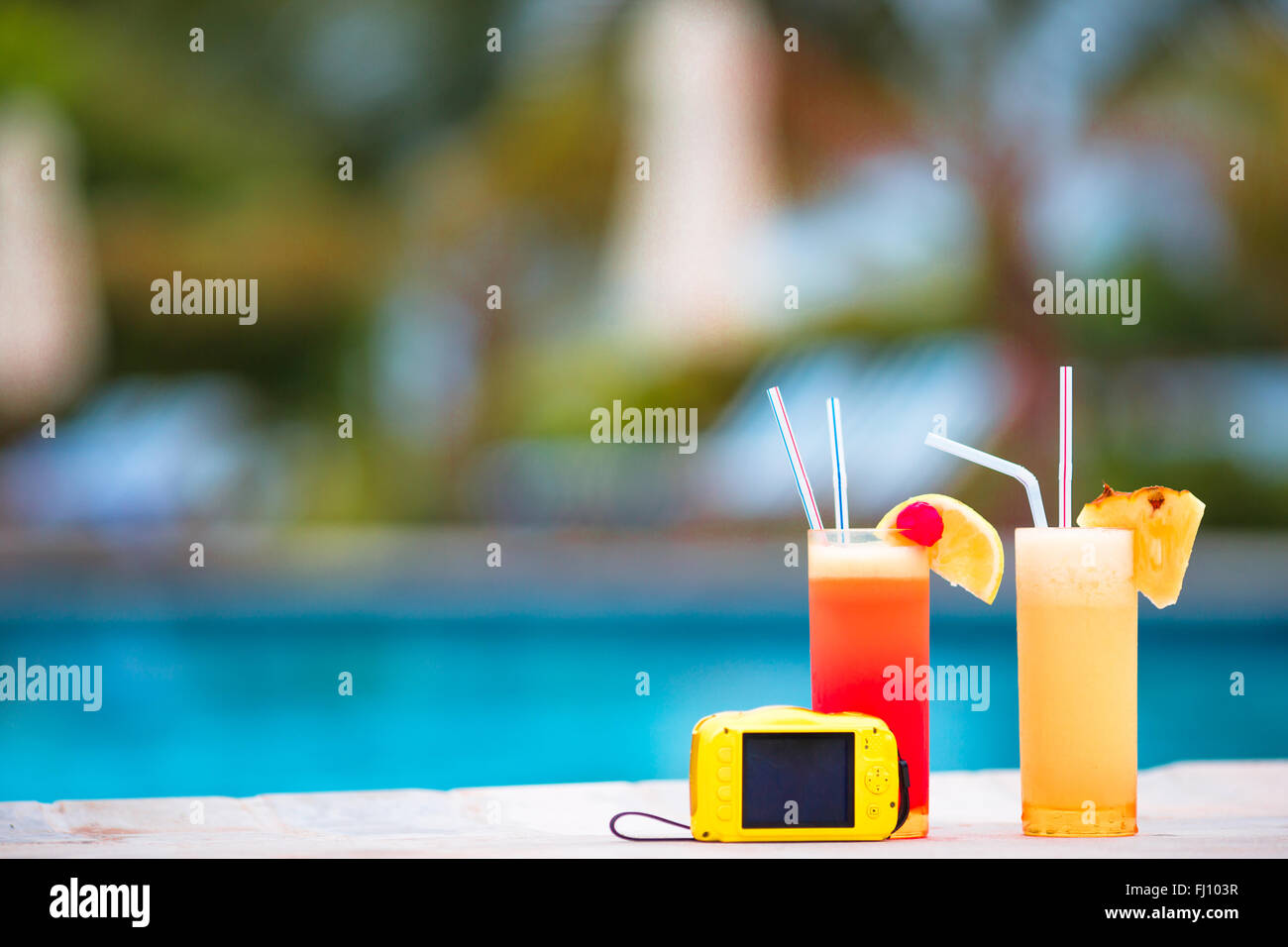 Two tasty cocktails with camera on tropical white beach Stock Photo - Alamy