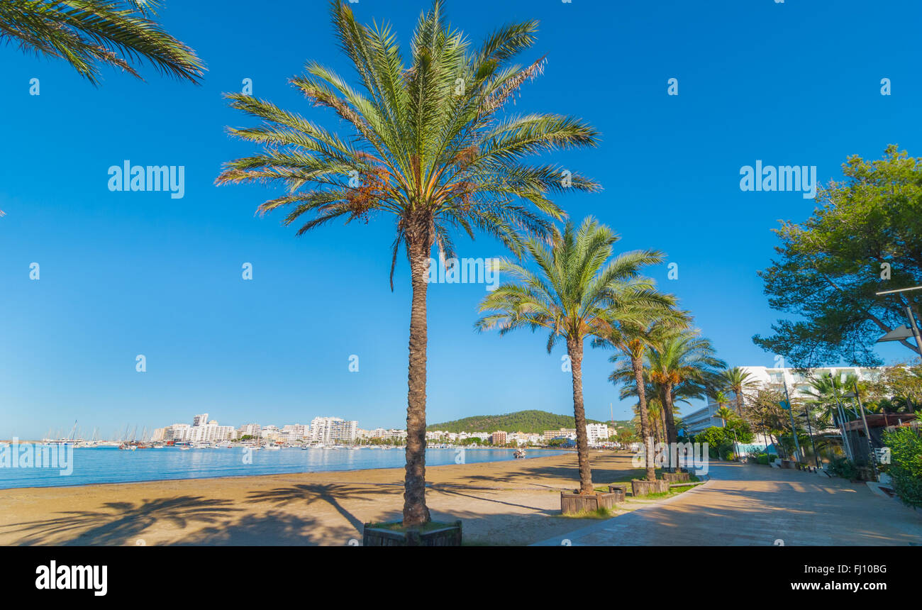 Mid morning sun on Ibiza waterfront. Warm sunny day along the beach in ...