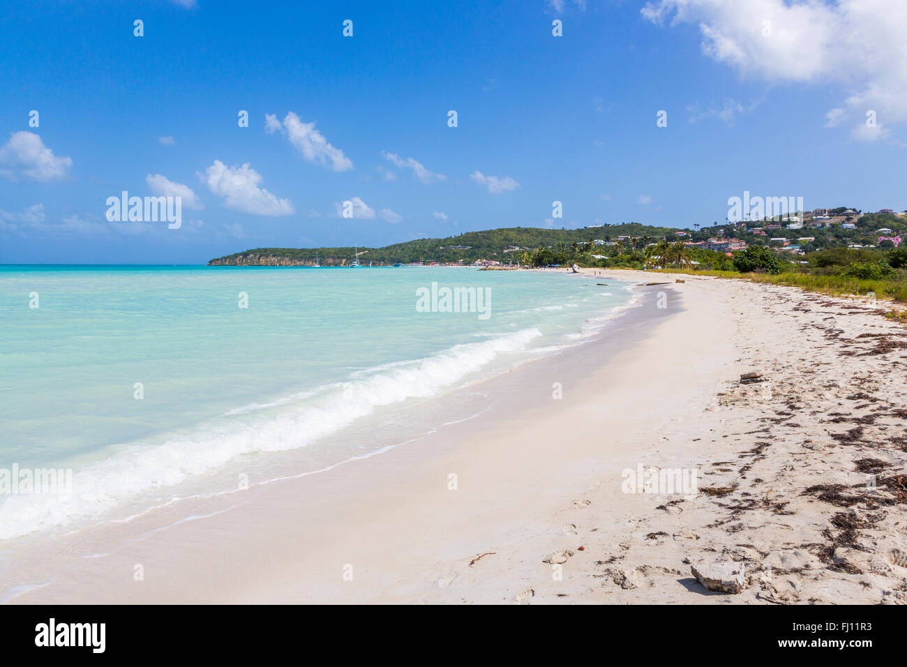 View of the unspoilt and popular sweeping Dickenson Bay beach in north ...