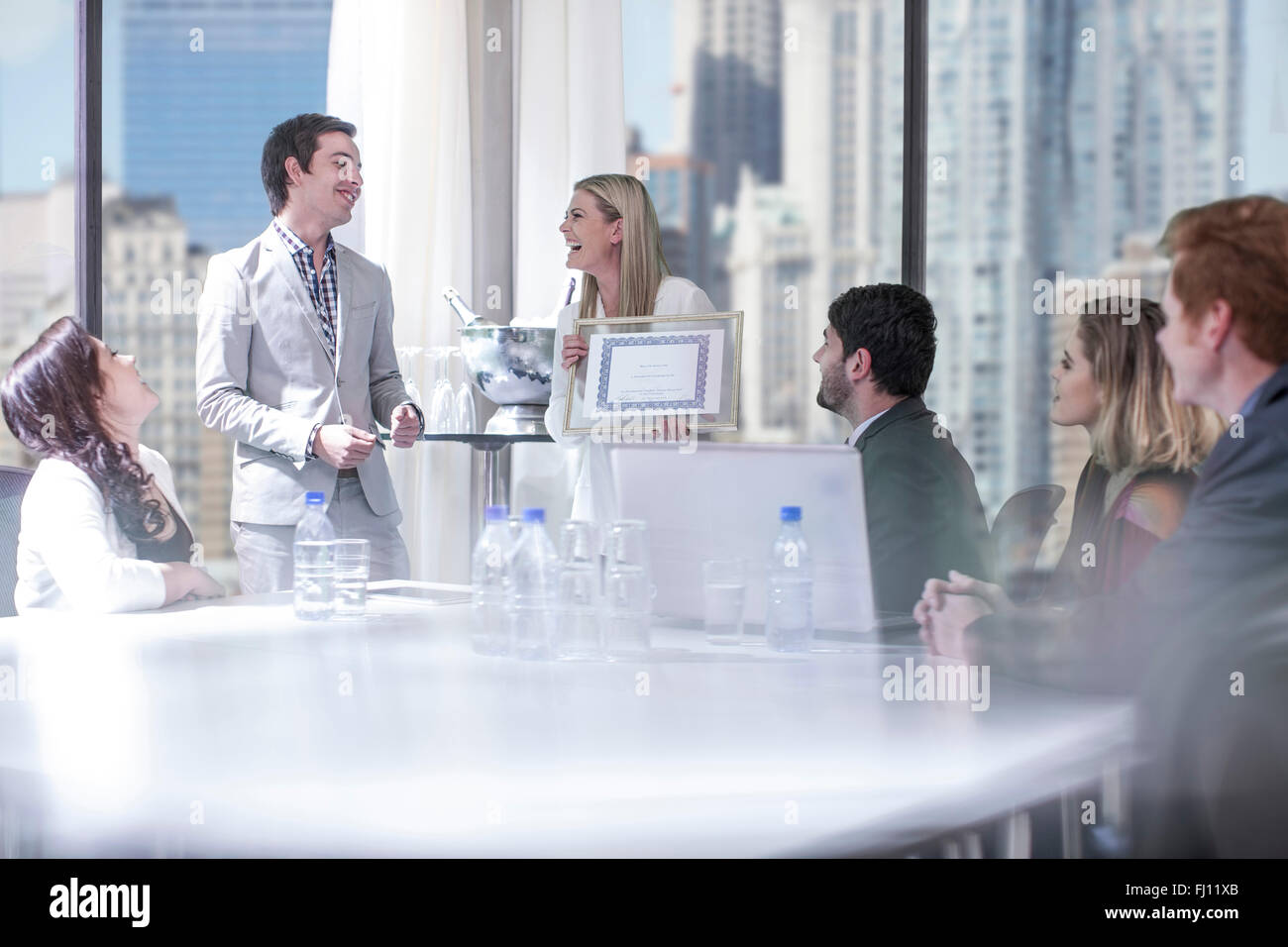 Successful business people celebrating awards in boardroom Stock Photo ...