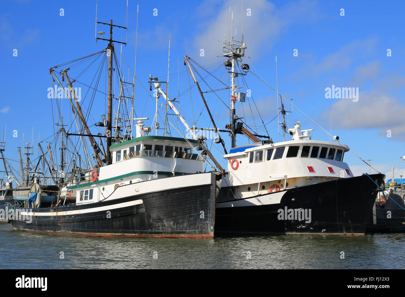 Two fishing boats moored together in Steveston Village, BC, Canada ...