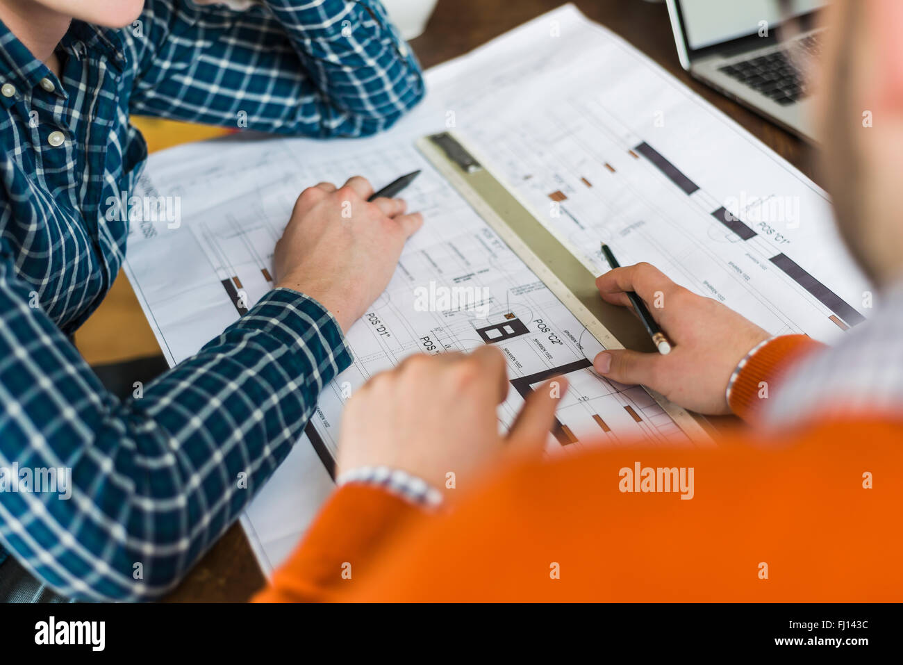 Two colleagues discussing plan in office Stock Photo - Alamy