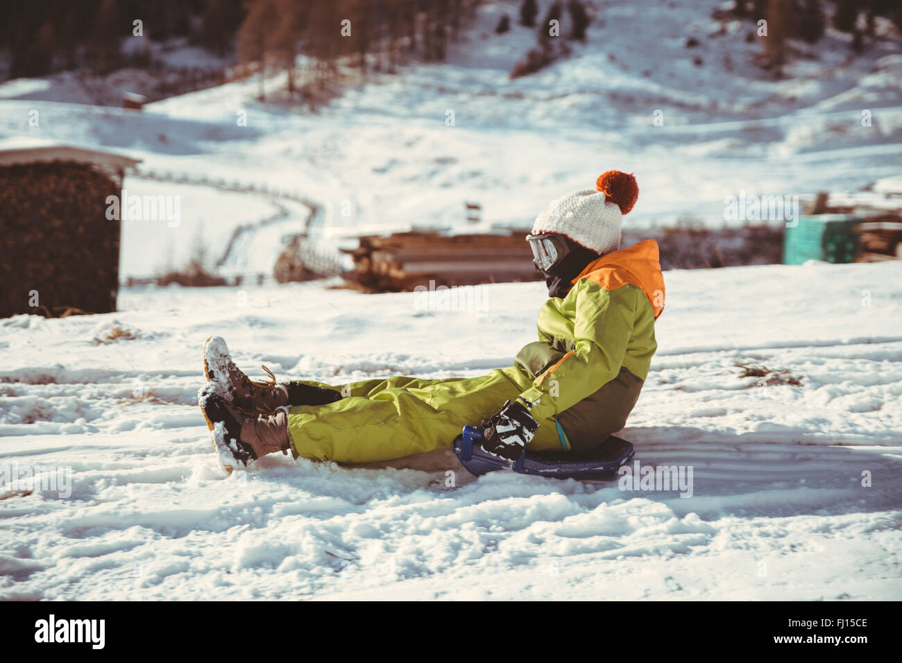 Italy, Val Venosta, Slingia, boy sleighing down a snowy hill Stock ...