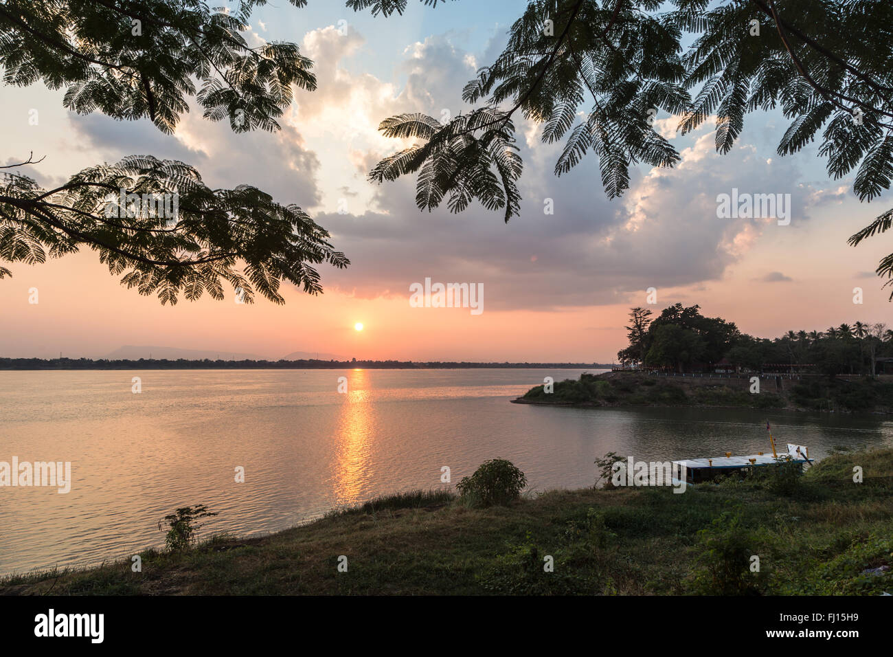 Stunning sunset over the Mekong river in Pakse in Champasak province in ...