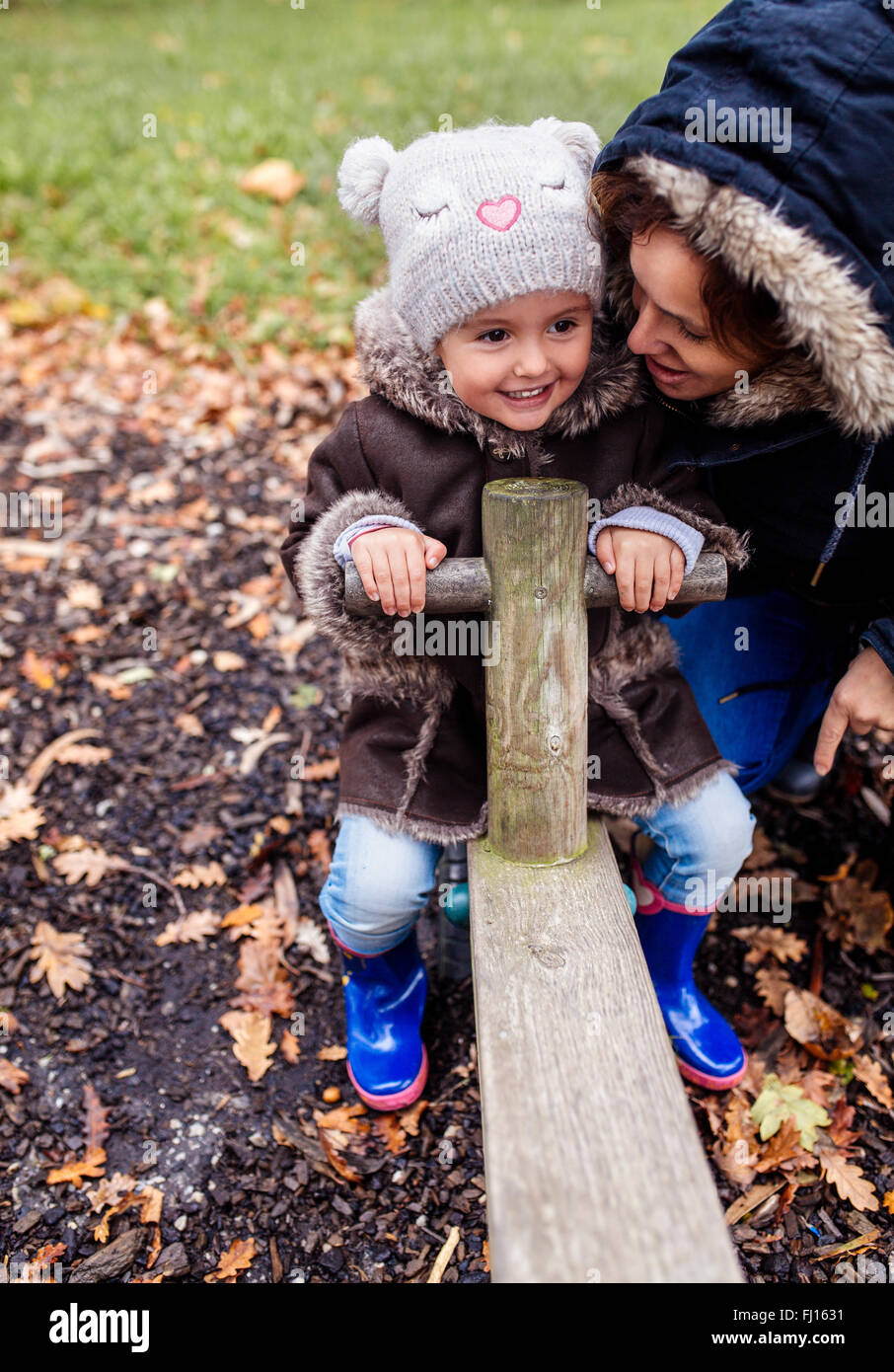 Happy little girl sitting on a rocker in autumn Stock Photo - Alamy