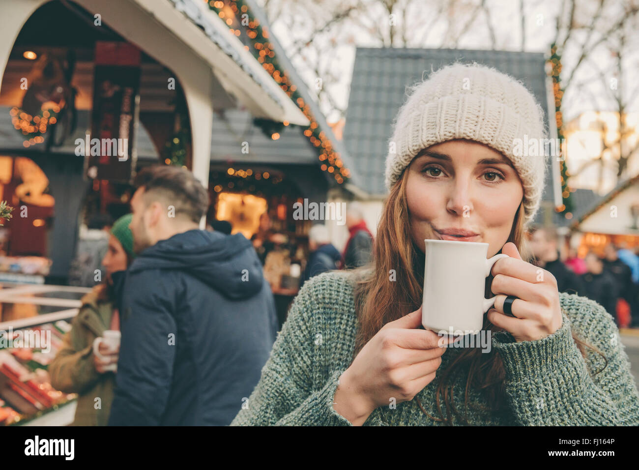 Woman having a hot punch on the Christmas Market Stock Photo - Alamy