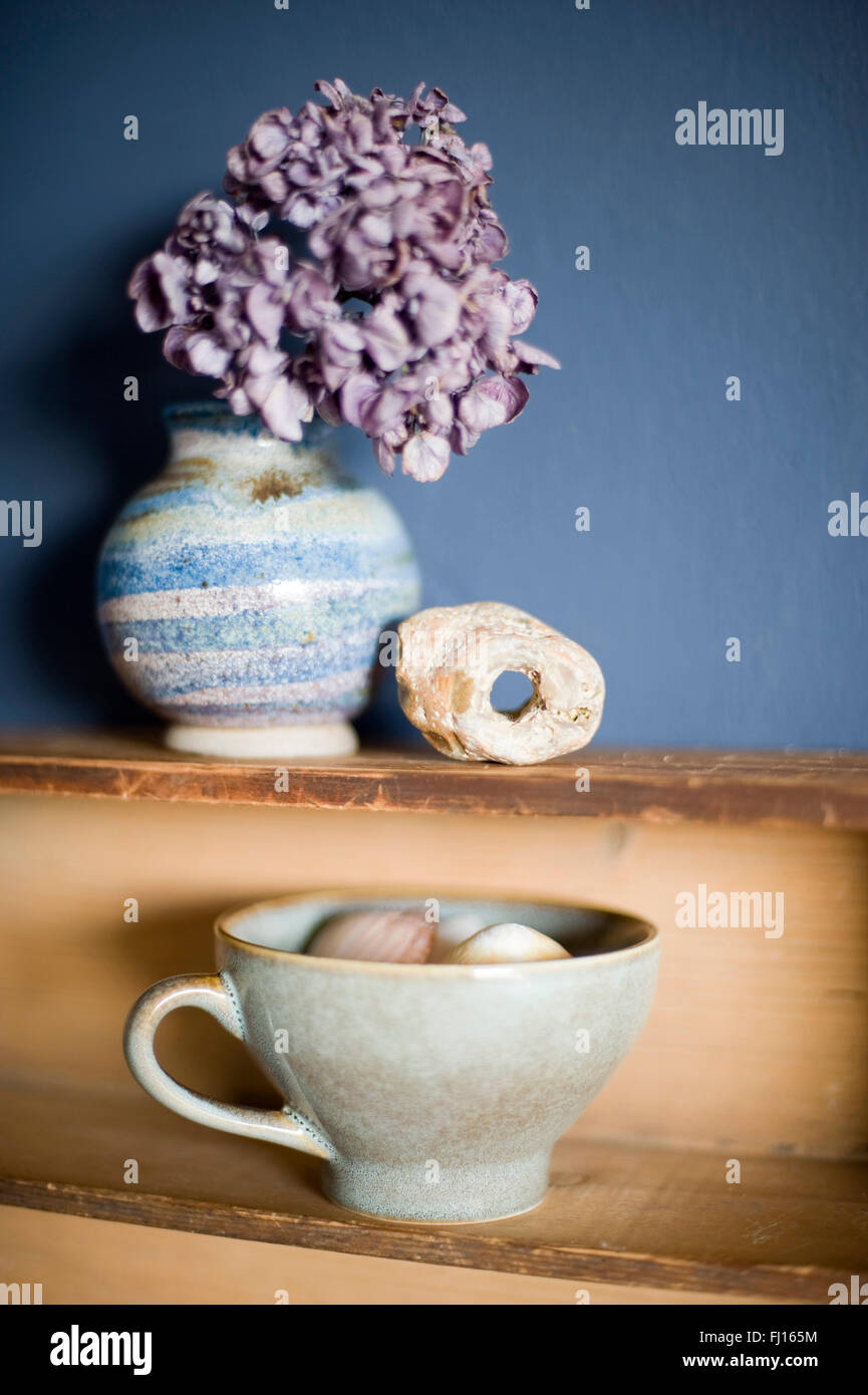 Still life with cider cup, hydrangea in vase and adder stone Stock ...