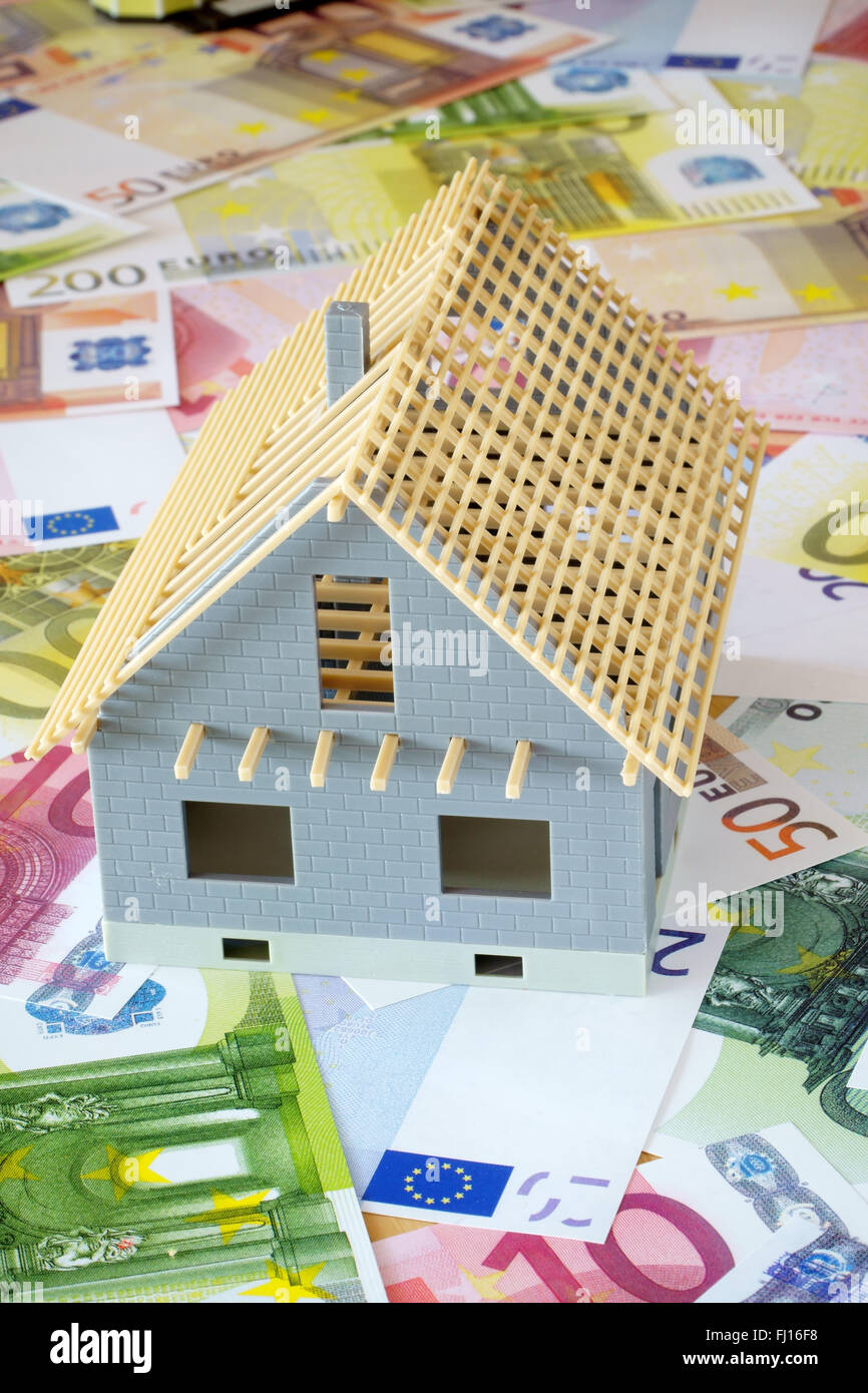 Model of a house new building on a background made of Euro banknotes ...