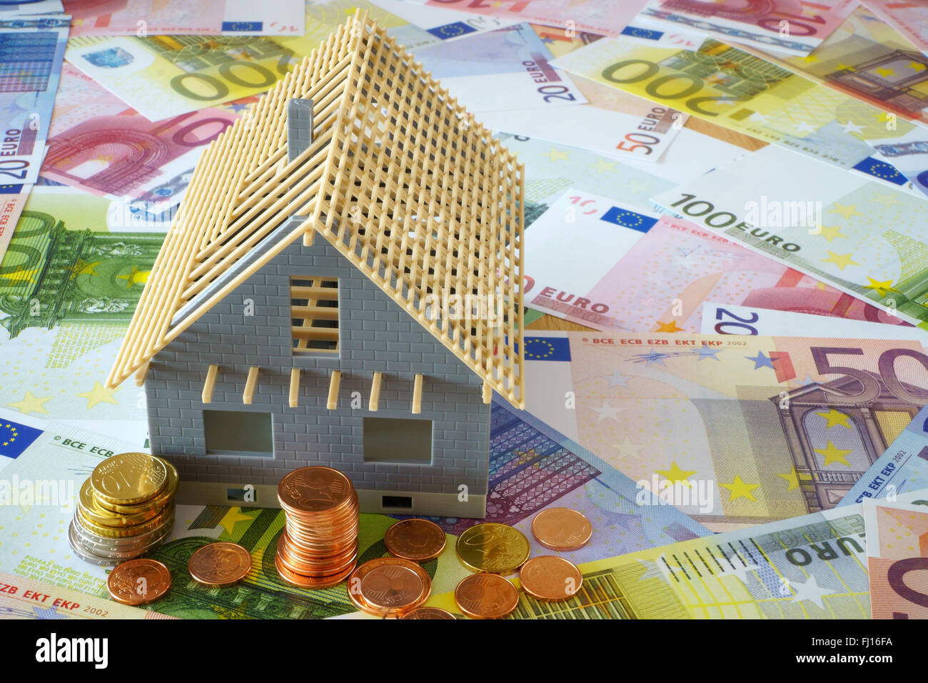 Model of a house new building on a background made of Euro banknotes ...