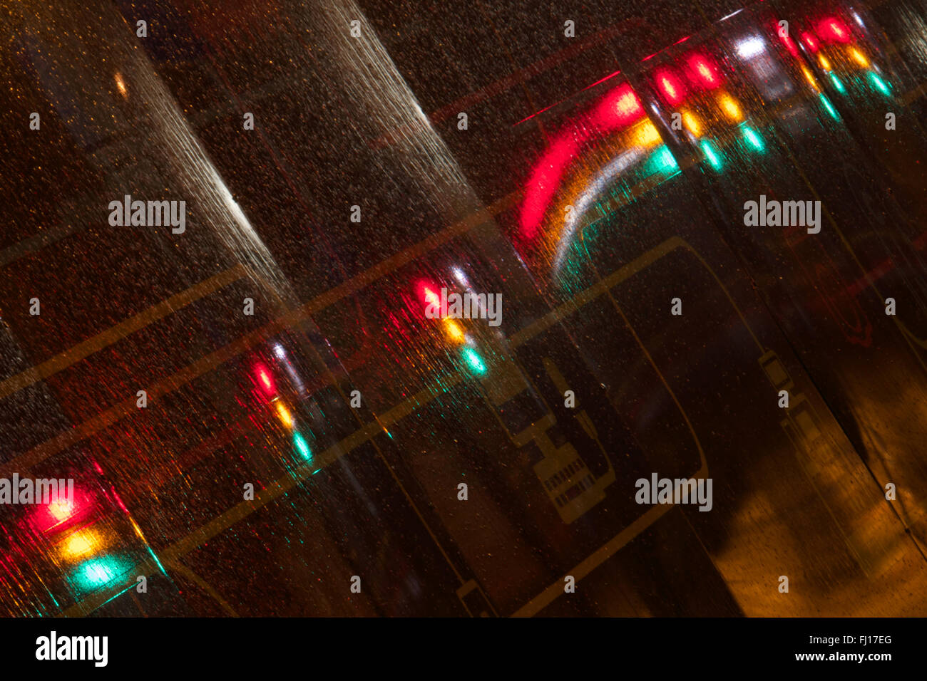 Traffic lights at night reflected in hoarding Stock Photo - Alamy