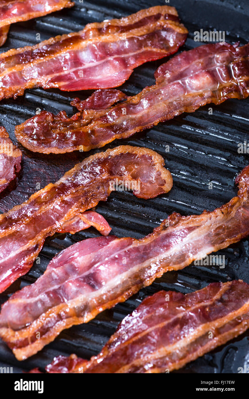 Portion of fried Bacon in a pan (close-up shot Stock Photo - Alamy