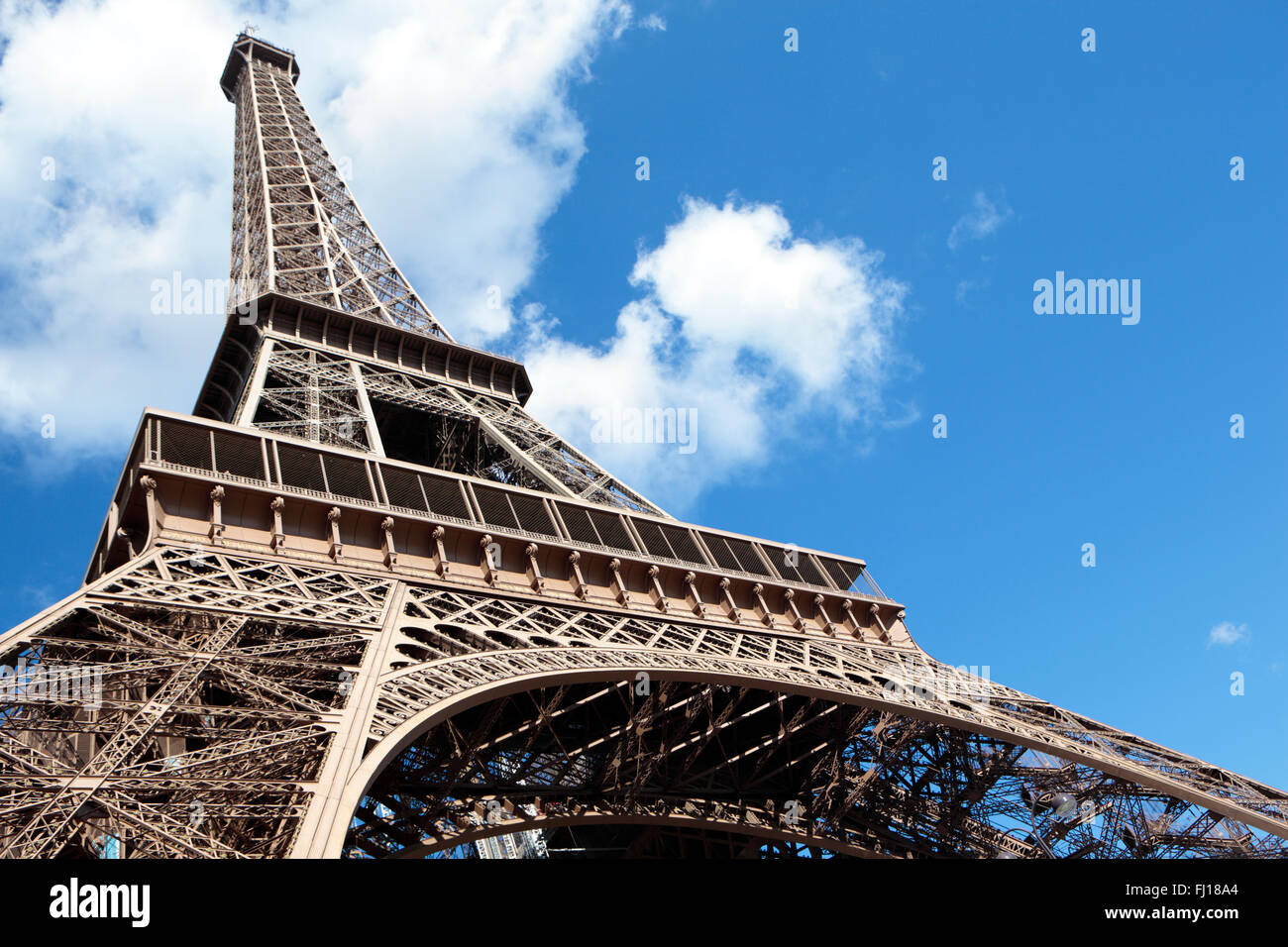 Wide low angle view of Eiffel Tower looking upwards into blue sky, copy ...