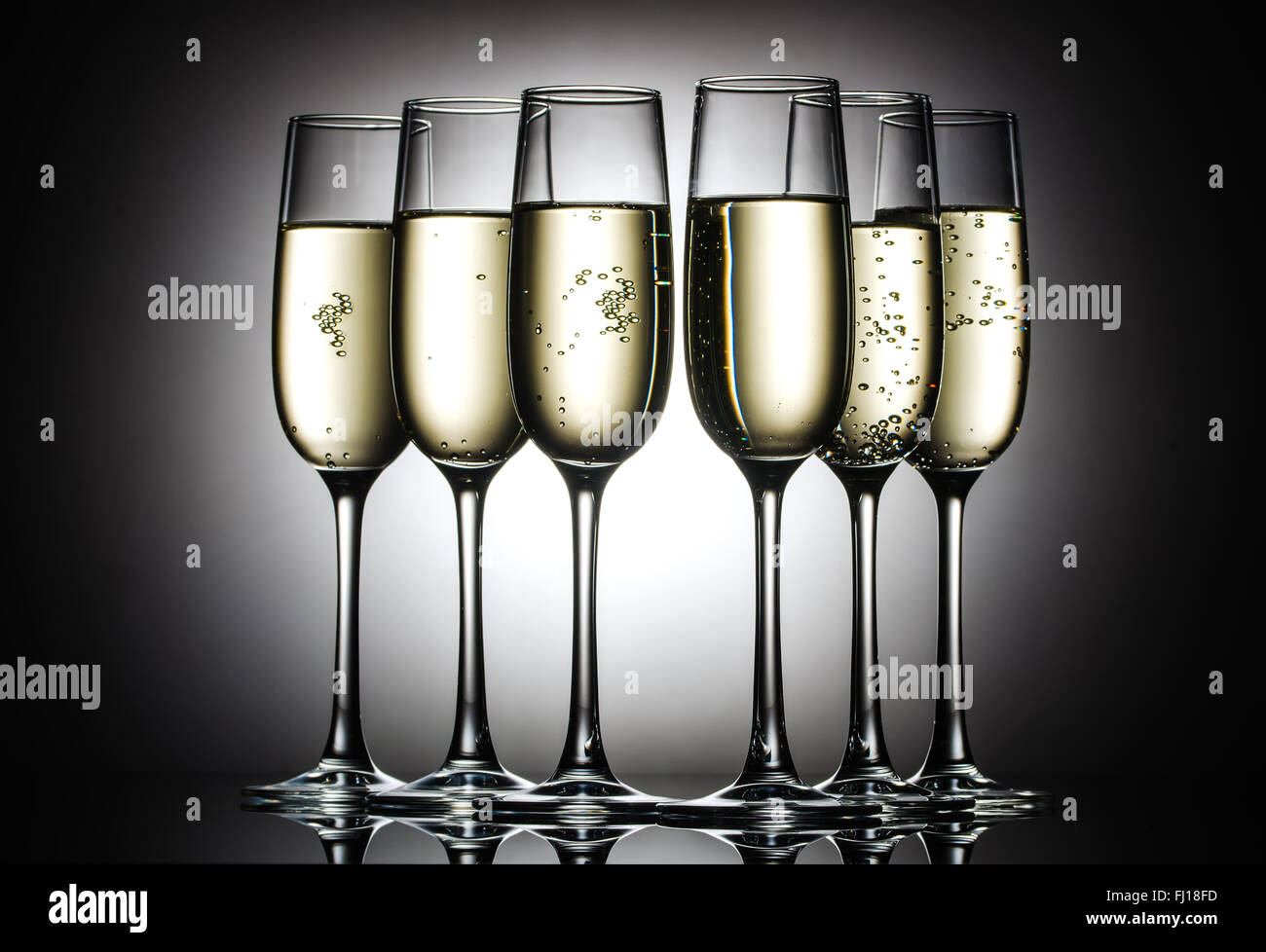 close-up shiny champagne glasses with bubbles on grey background Stock ...