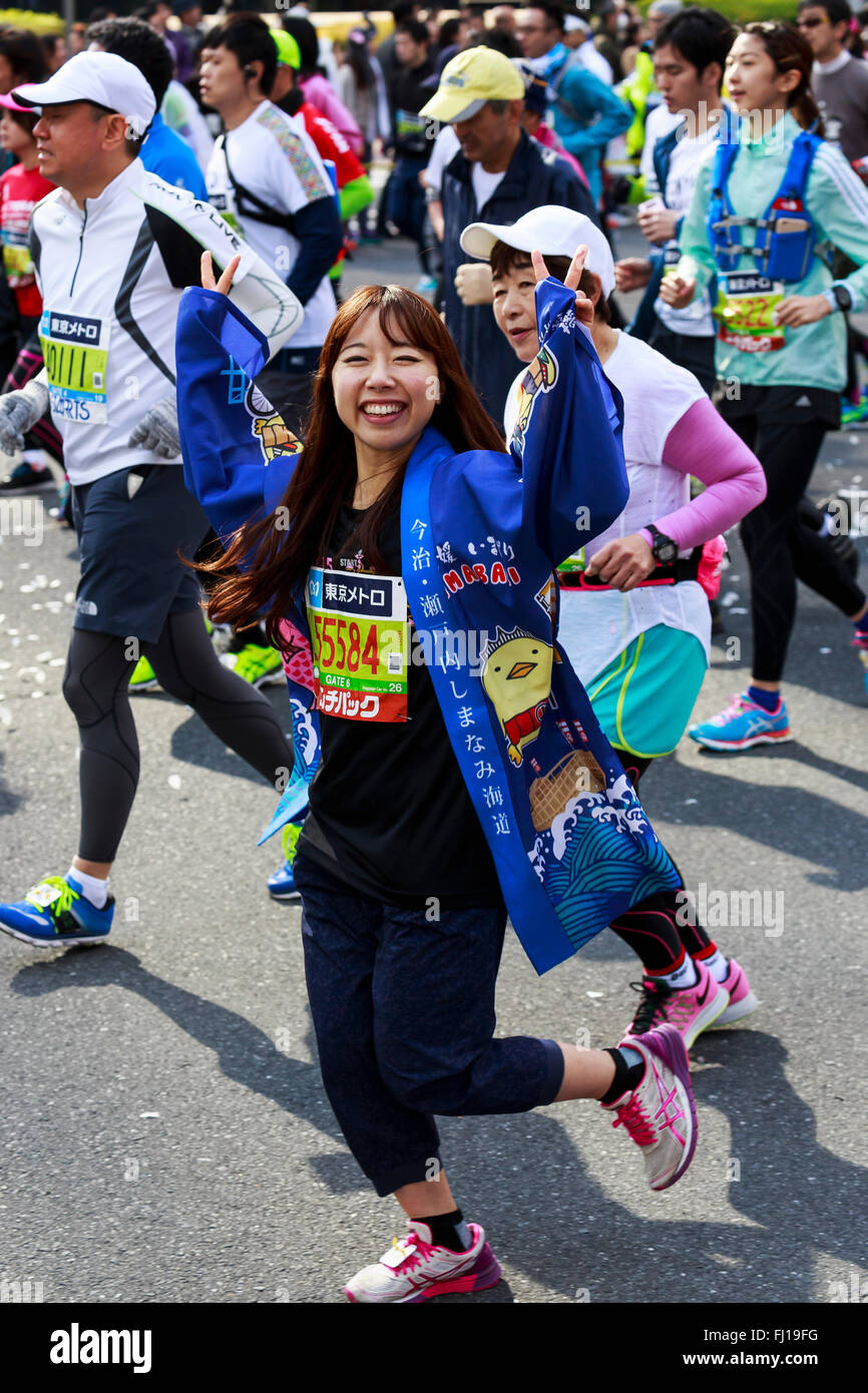 Runners race through Shinjuku during the Tokyo Marathon on February 28 ...