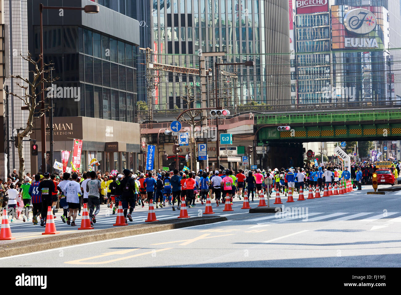 Runners race through Hibiya during the Tokyo Marathon on February 28 ...
