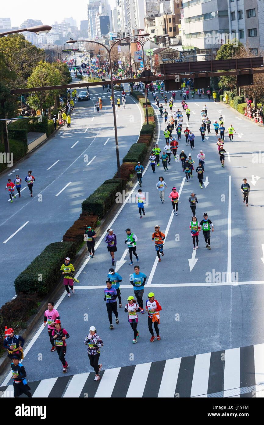 Runners race through Iidabashi during the Tokyo Marathon on February 28 ...