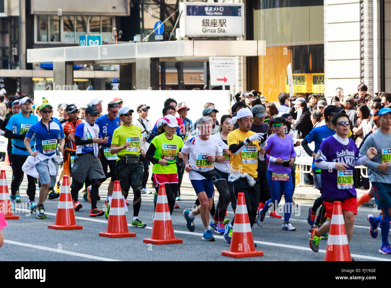 Runners race through Ginza during the Tokyo Marathon on February 28 ...