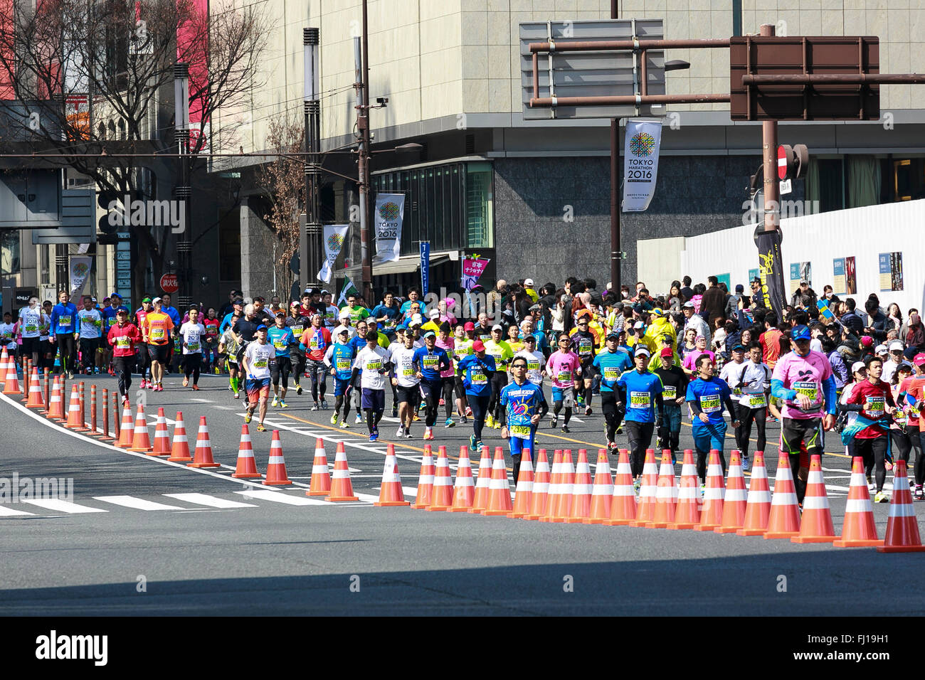 Runners race through Ginza during the Tokyo Marathon on February 28 ...