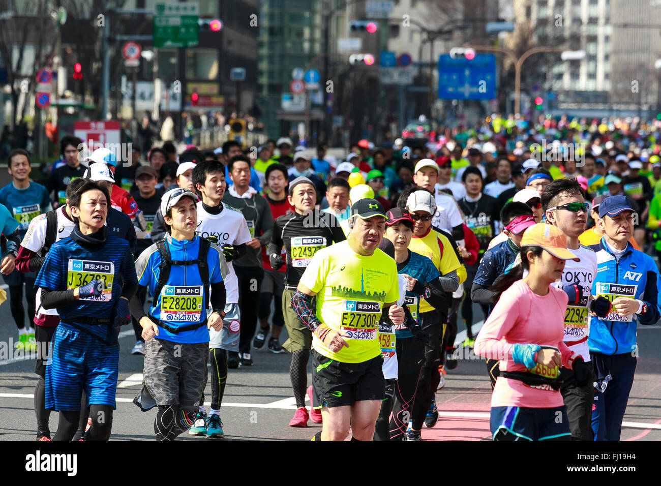 Runners race through Ginza during the Tokyo Marathon on February 28 ...
