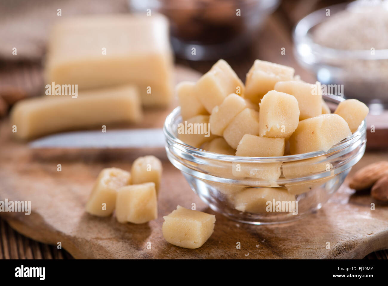 Portion of Marzipan (close-up shot) on wooden background Stock Photo ...