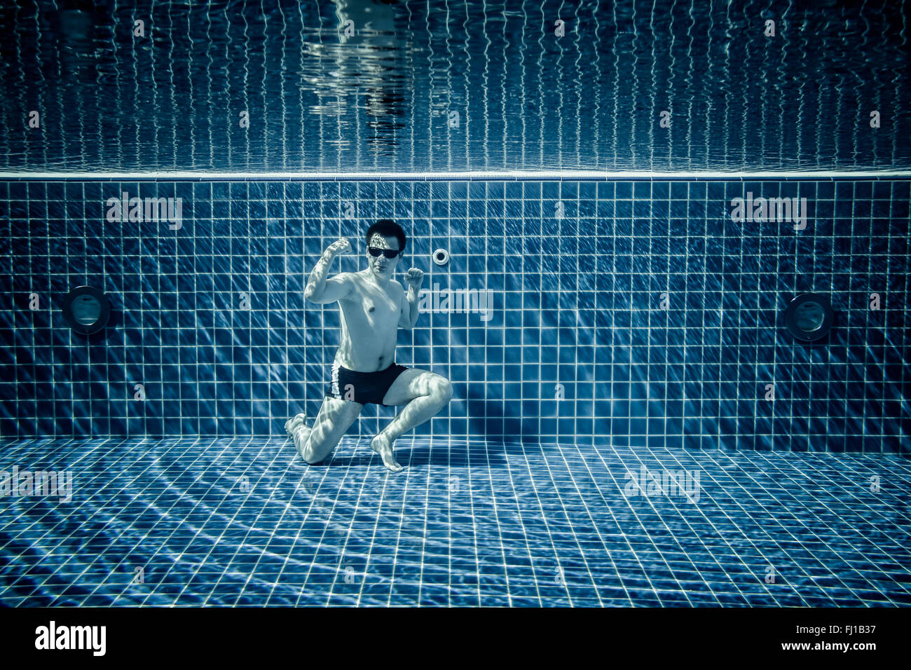 Man posing as Superman underwater swimming pool Stock Photo - Alamy