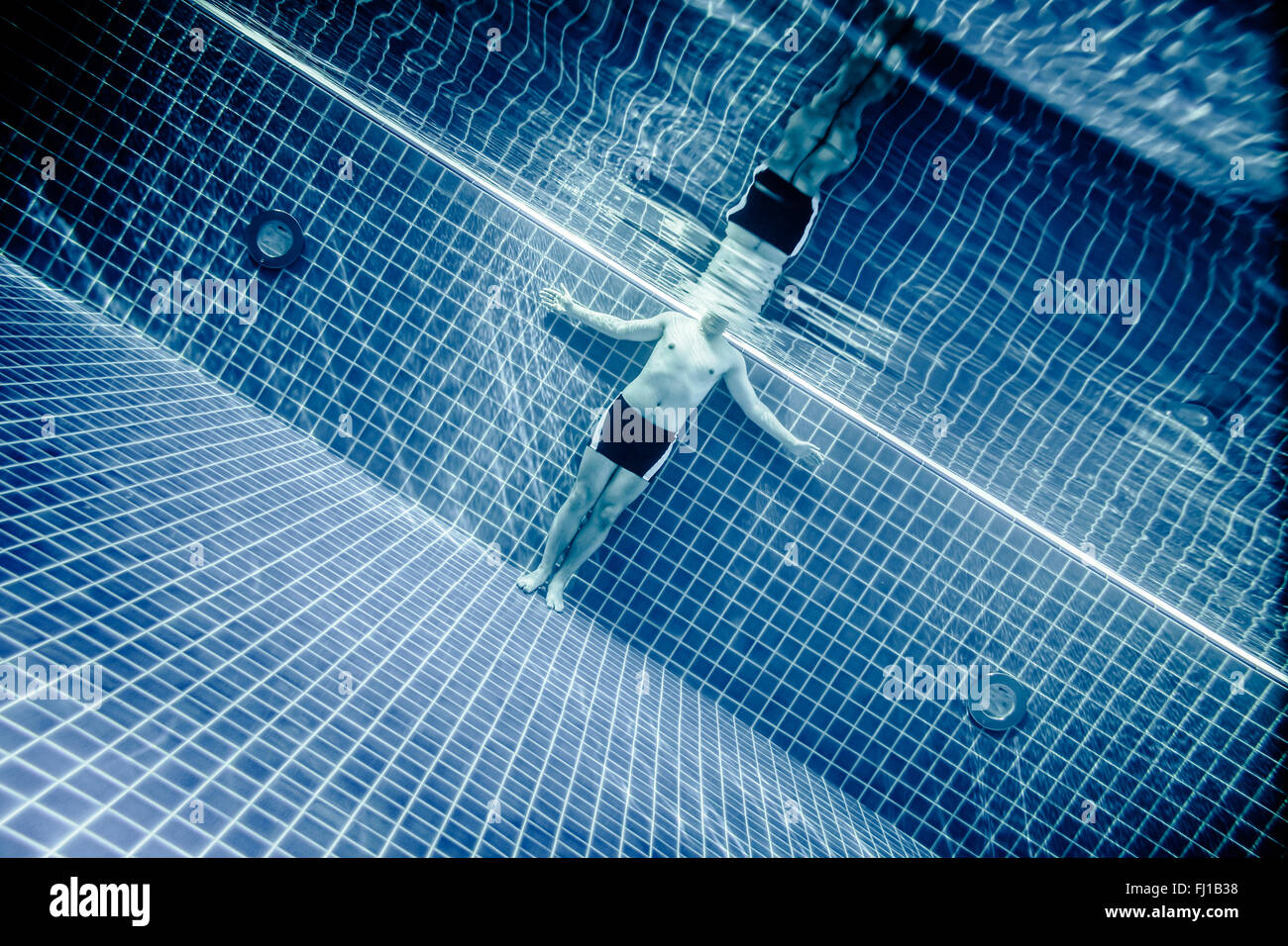 Man standing under water in a swimming pool Stock Photo - Alamy