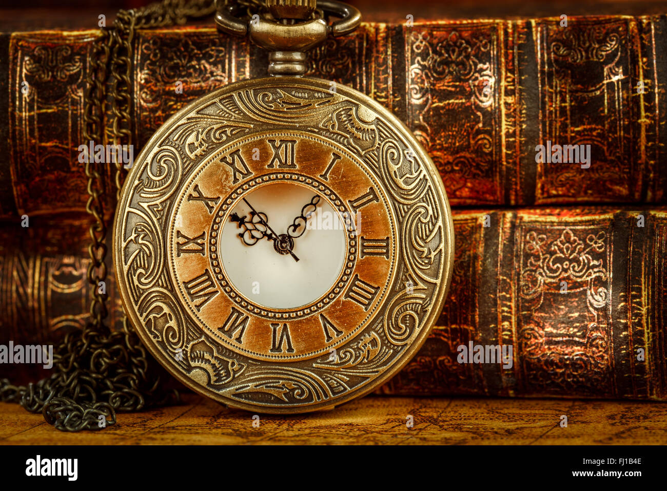 Vintage Antique pocket watch on the background of old books Stock Photo ...
