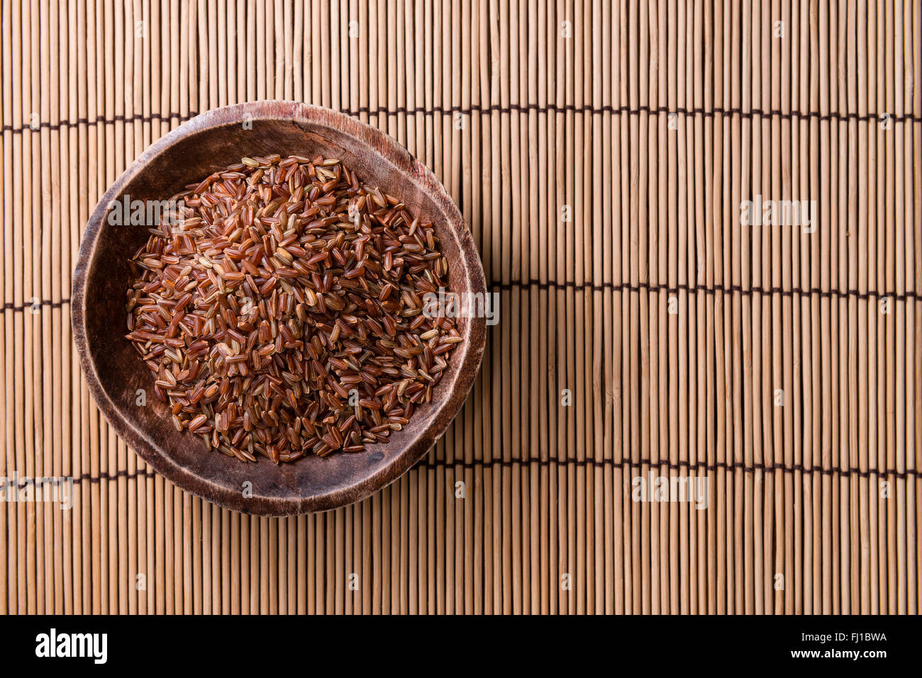 Portion of red Rice (close-up shot) on wooden background Stock Photo ...