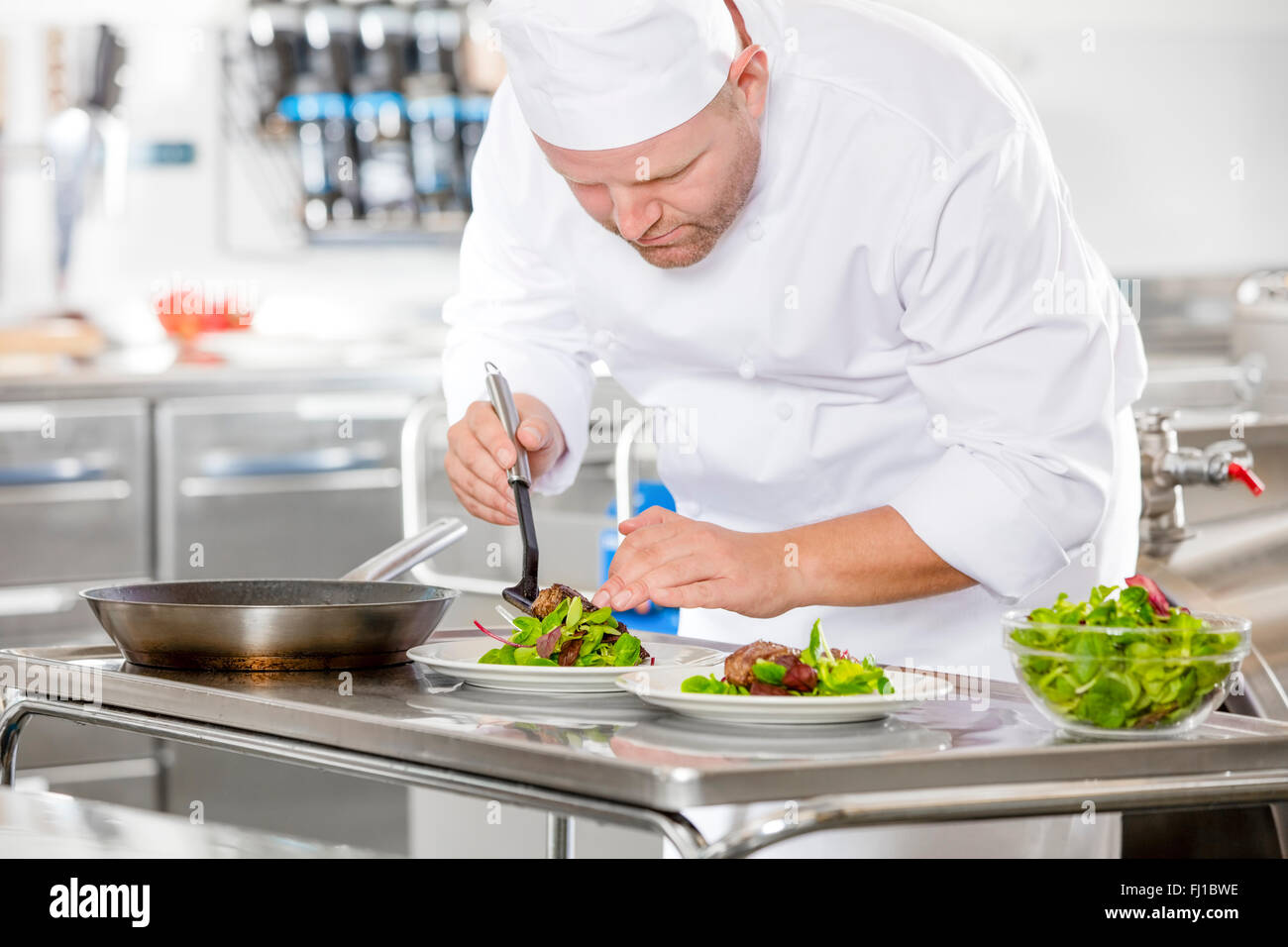 Professional chef prepare steak dish at restaurant Stock Photo - Alamy