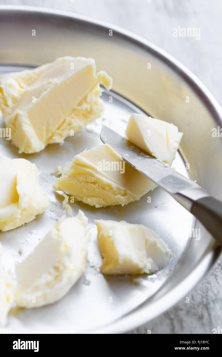 Pieces of fresh butter in a small aluminium pan Stock Photo - Alamy
