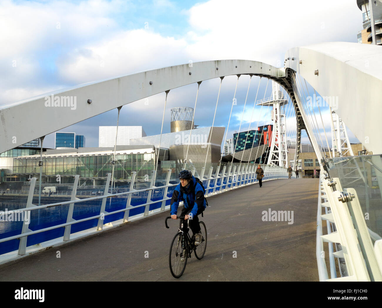 Cyclist crossing the over the River Irwell between Manchester and ...