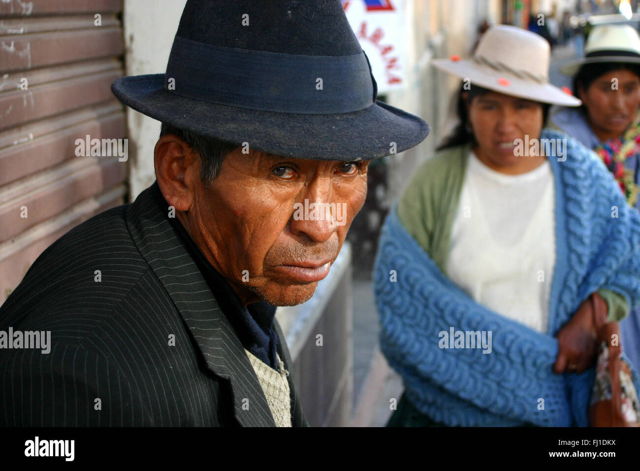 Bolivian man and two ladies in the streets of Potosi, Bolivia, wearing ...